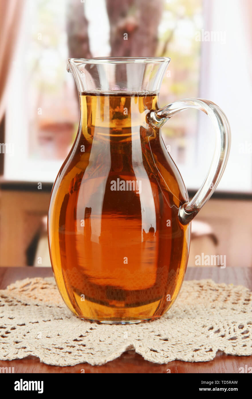Apple juice in pitcher on table in room Stock Photo - Alamy