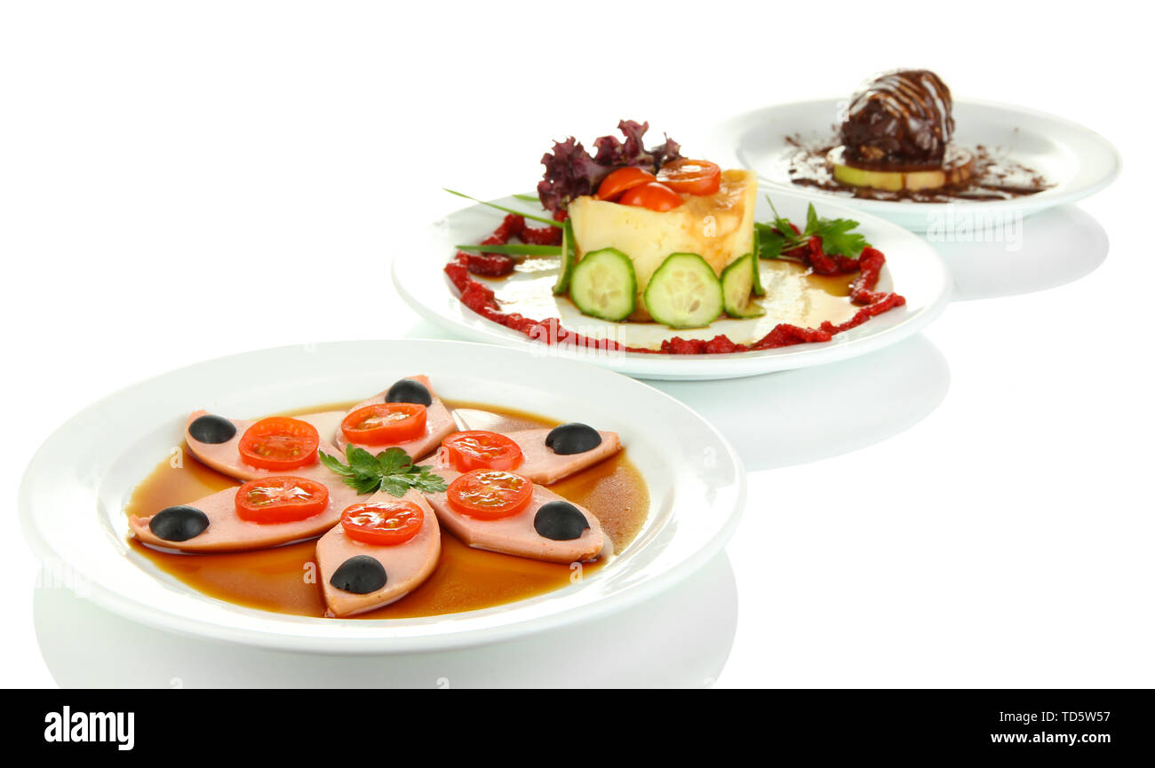 Small portions of food on big white plates isolated on white Stock ...