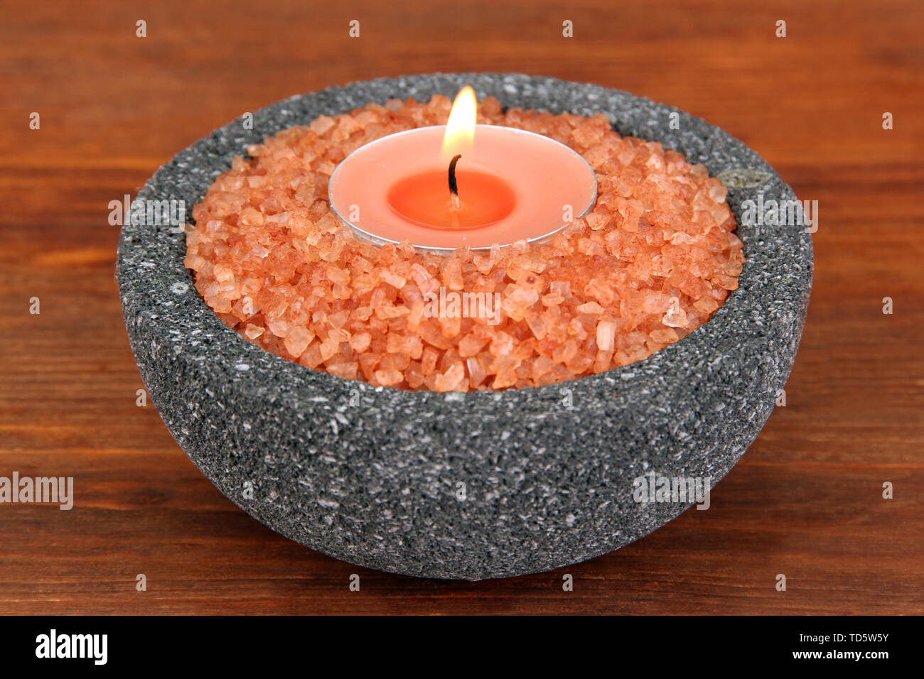 Candle in stone bowl with marine salt, on wooden background Stock Photo ...