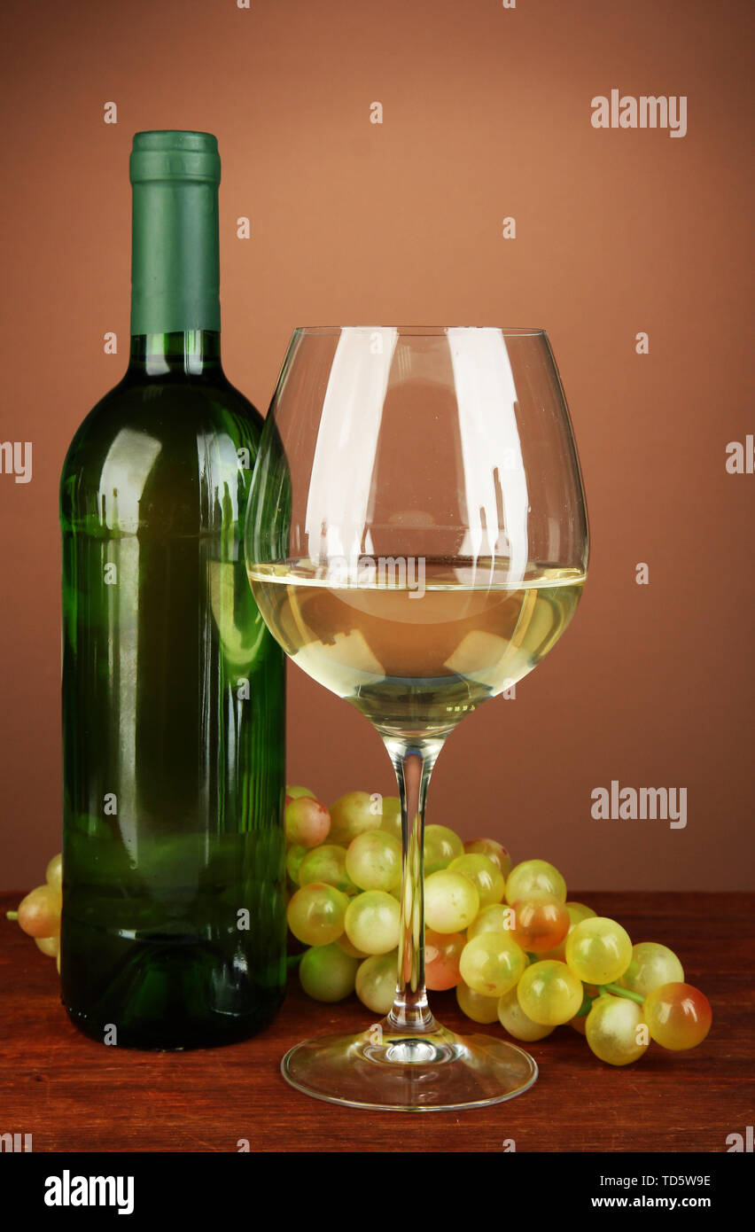 Composition of wine bottle, glass of white wine, grape on color ...