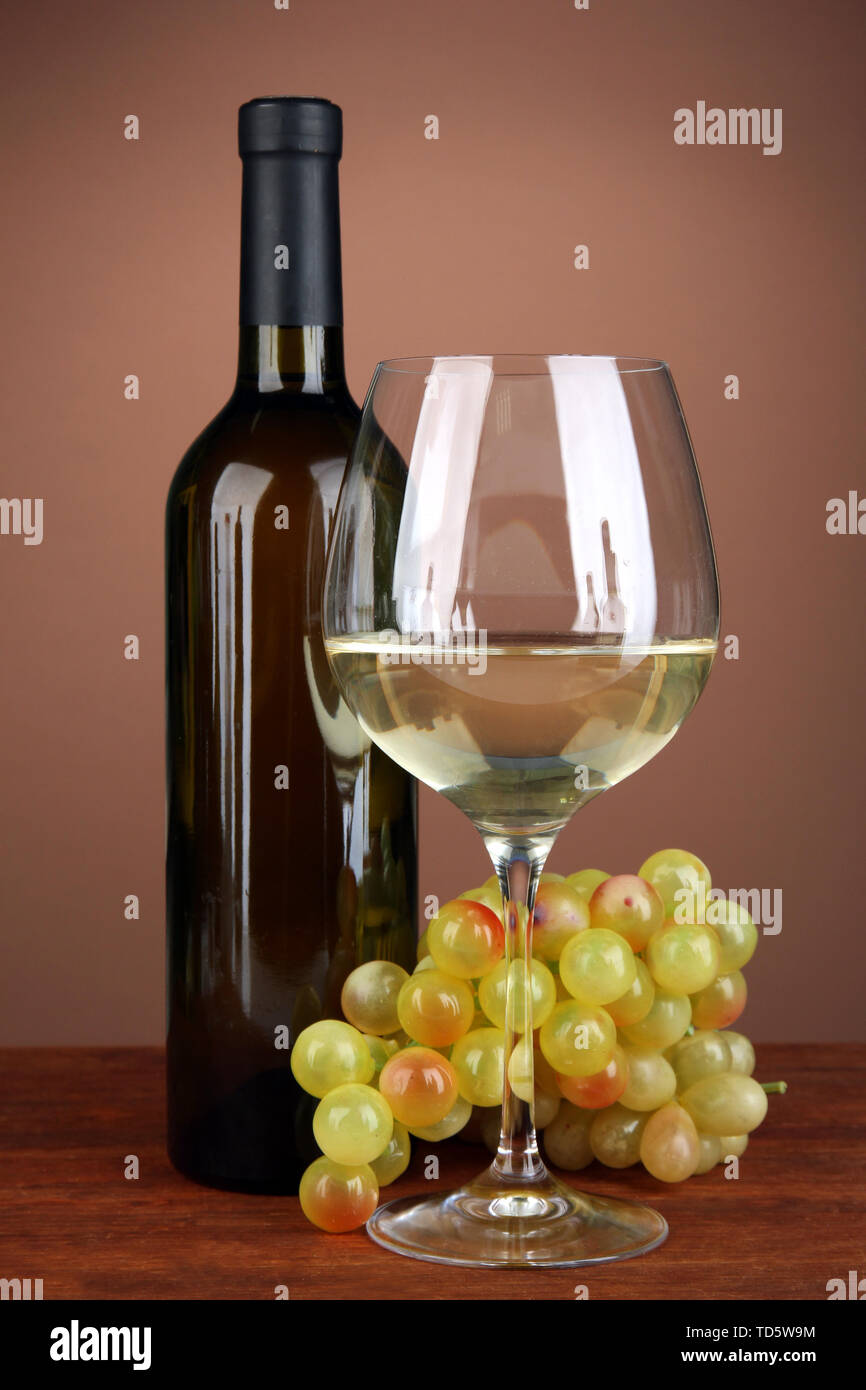 Composition of wine bottle, glass of white wine, grape on color ...