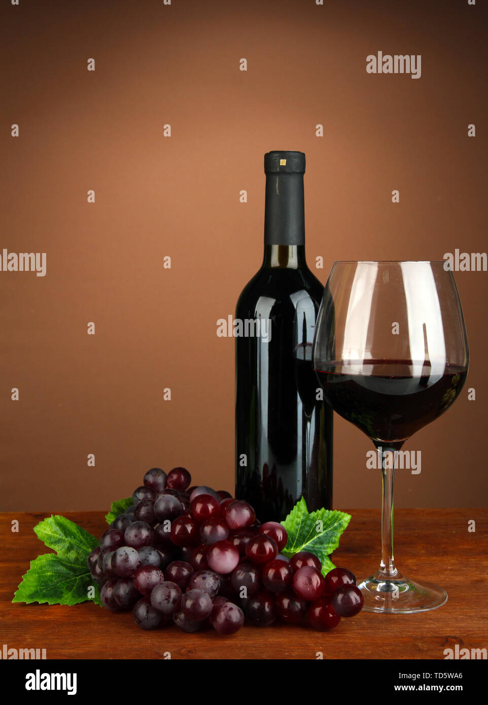 Composition of wine bottle, glass of red wine, grape on color ...