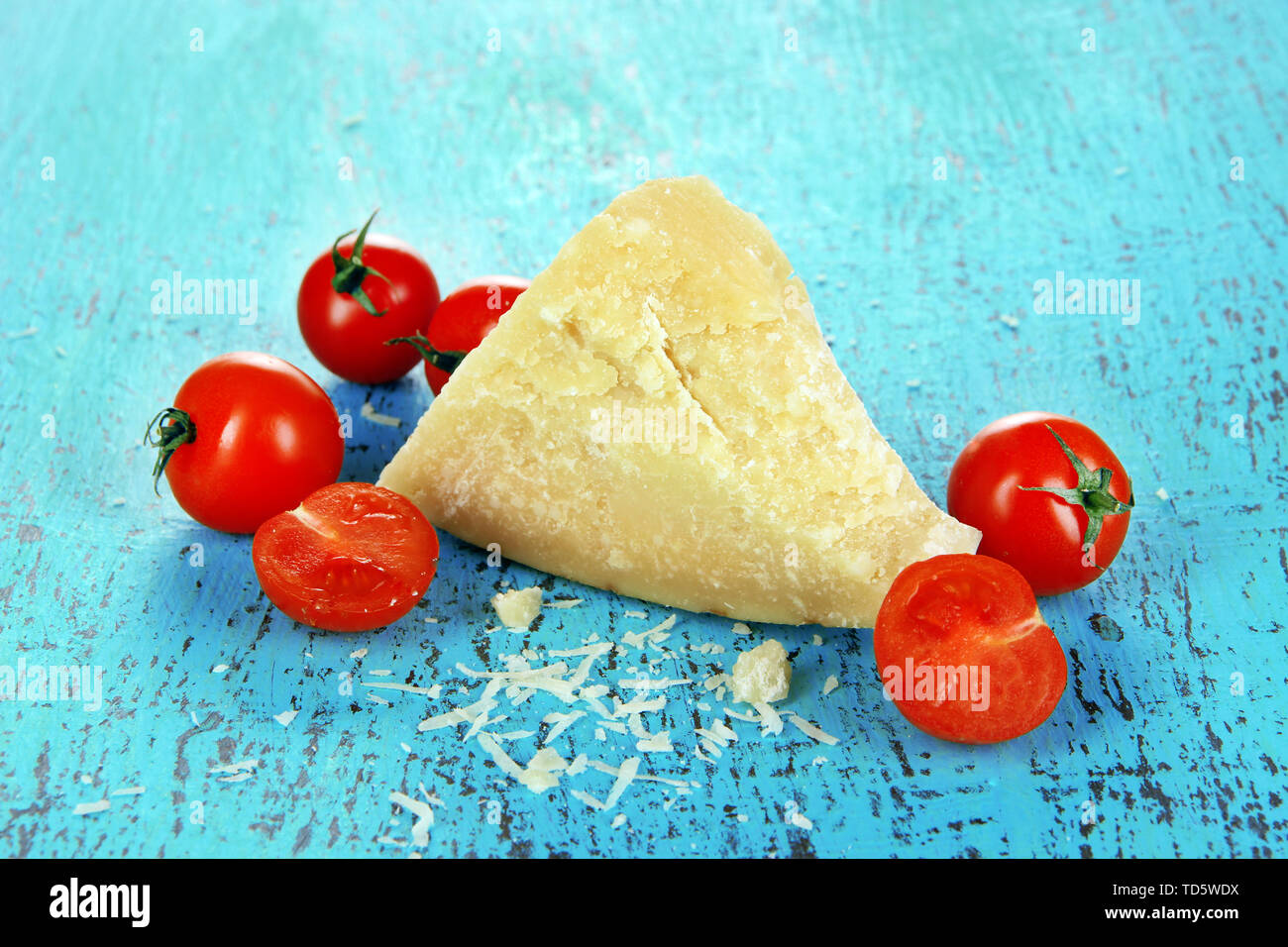 Piece of Parmesan cheese on wooden blue table close-up Stock Photo - Alamy