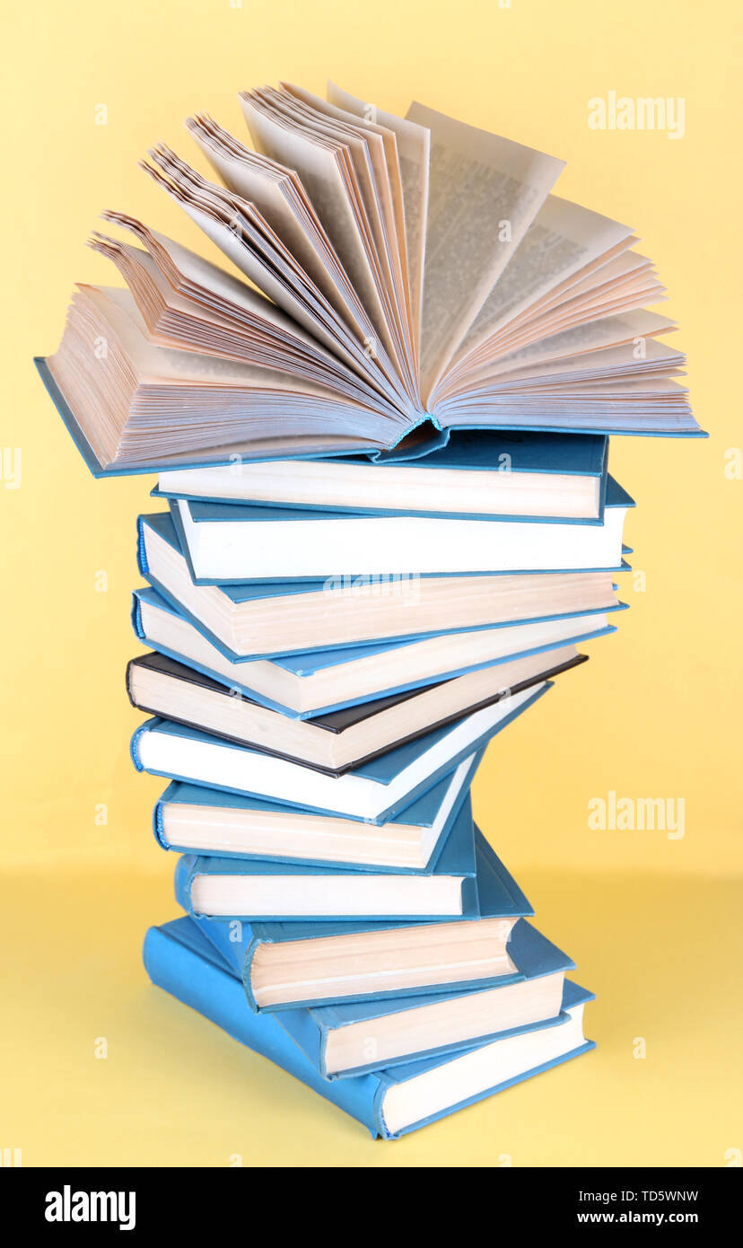 Spiral books on beige background Stock Photo - Alamy