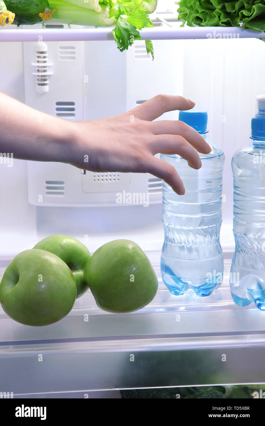 Reaching into refrigerator hi-res stock photography and images - Alamy