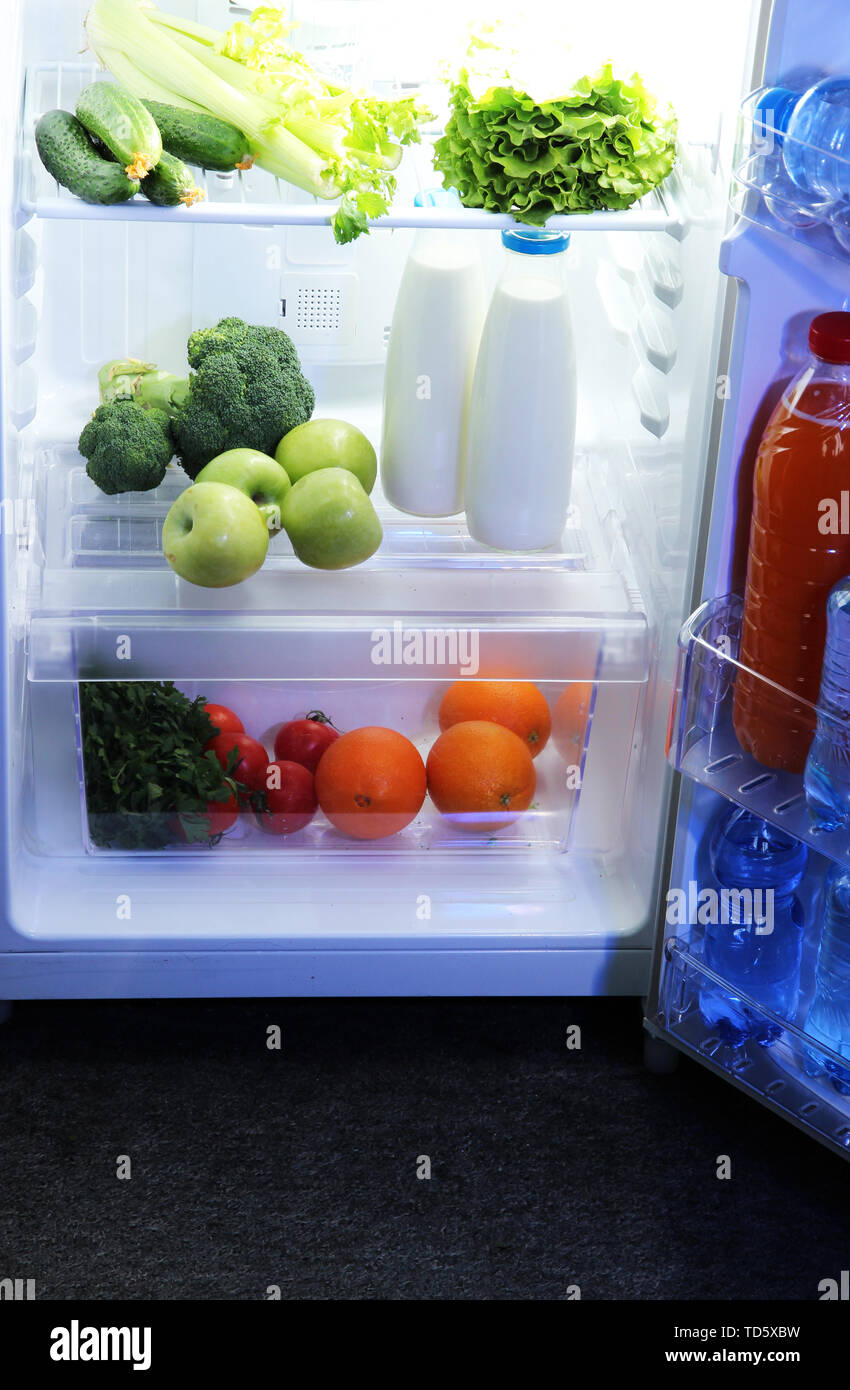 Woman's hand reaching out for food from the refrigerator, close up ...