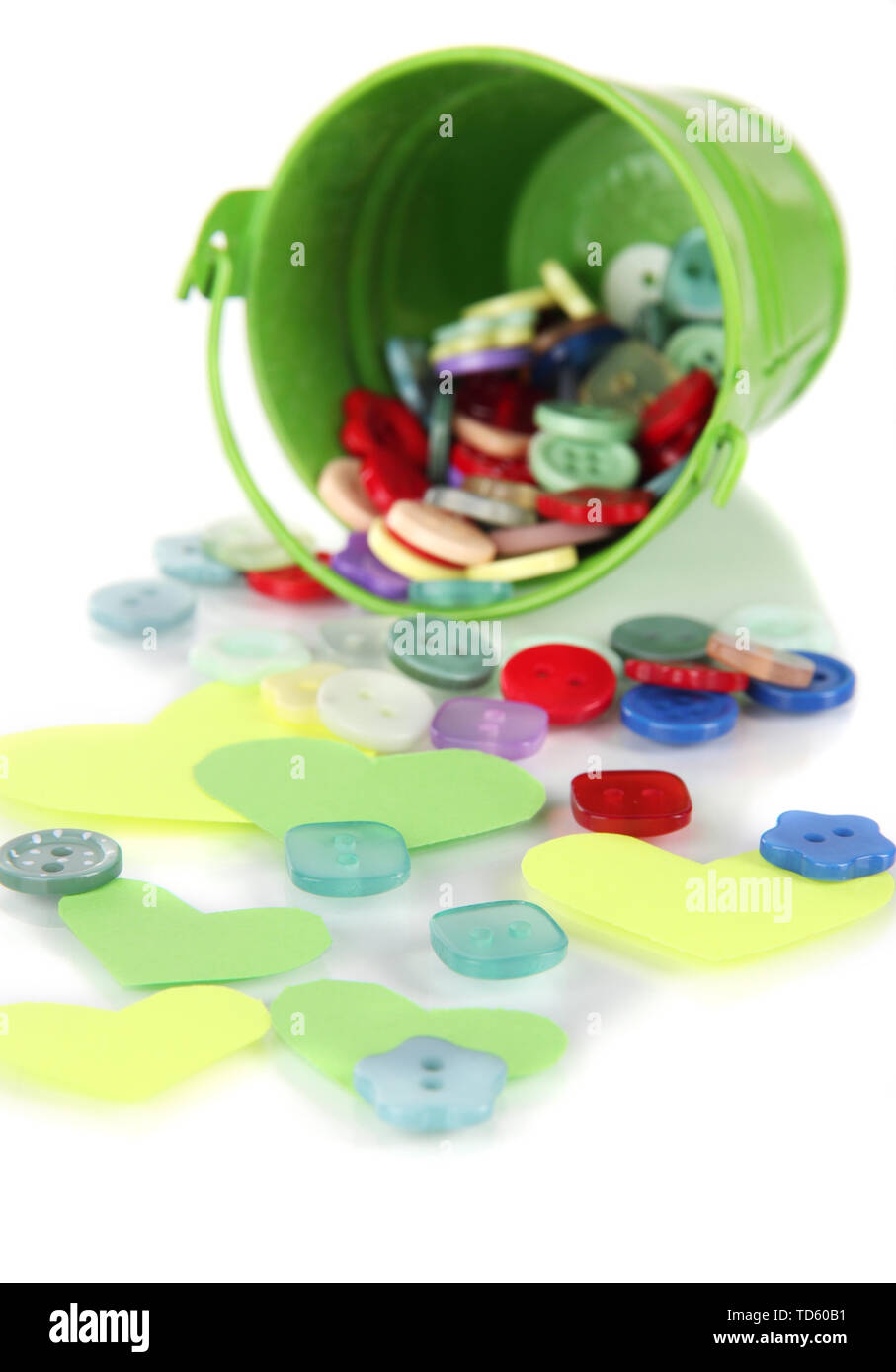 Colorful buttons strewn from bucket isolated on white Stock Photo - Alamy