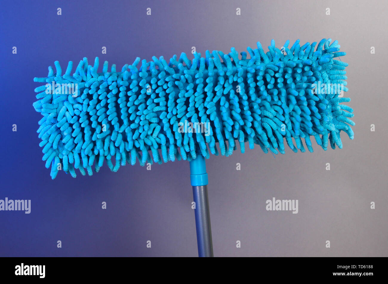 Blue mops for floor on bright background Stock Photo - Alamy