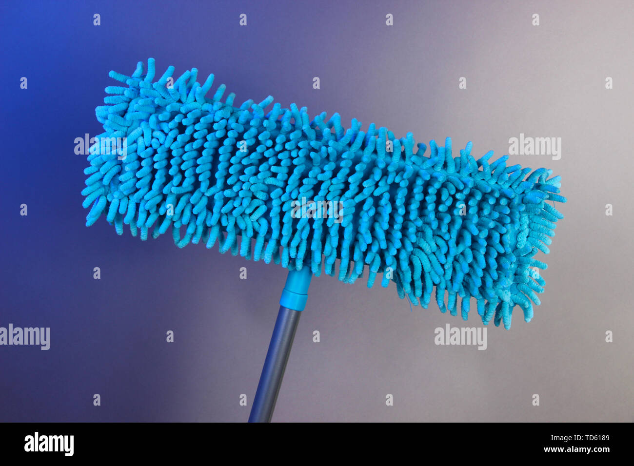 Blue mops for floor on bright background Stock Photo - Alamy