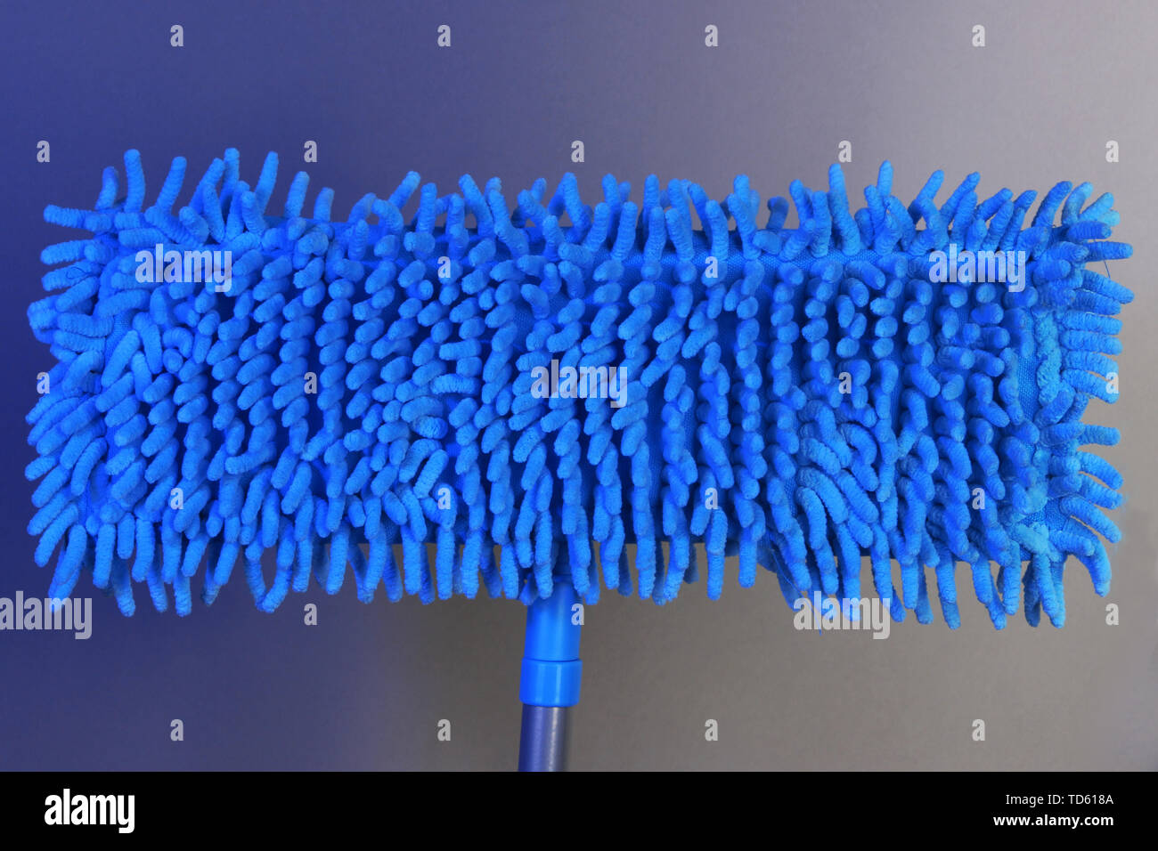 Blue mops for floor on bright background Stock Photo - Alamy