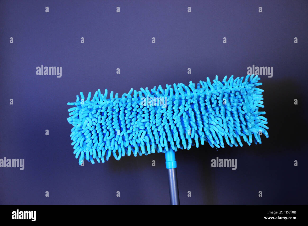 Blue mops for floor on bright background Stock Photo - Alamy