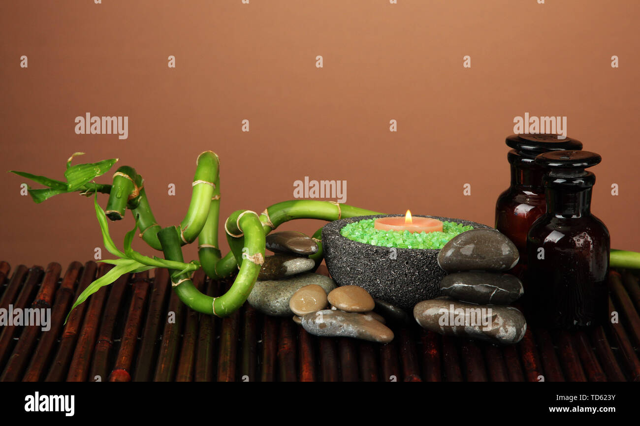 Still life with green bamboo plant and stones, on bamboo mat on color ...