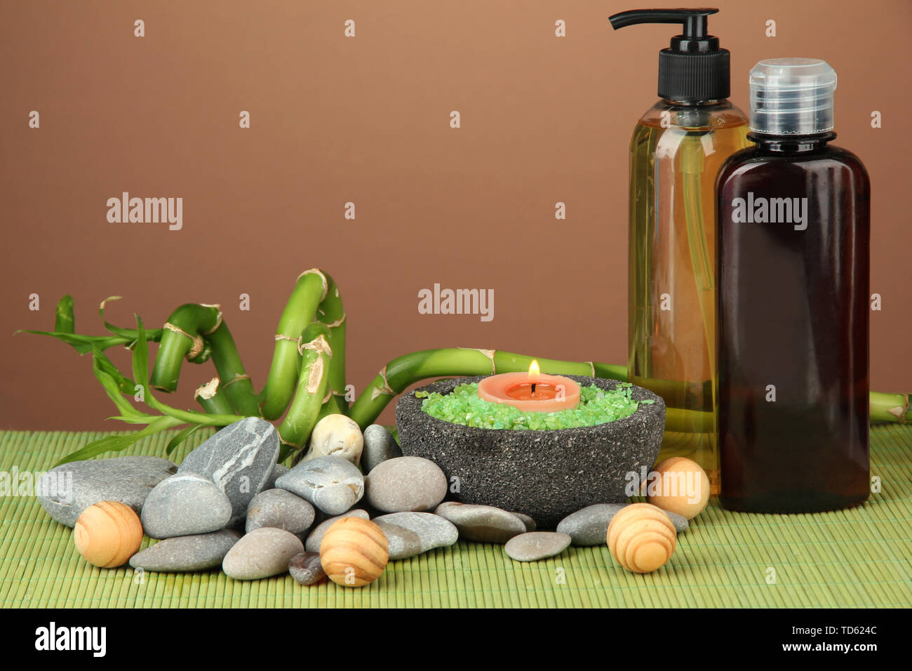 Still life with green bamboo plant and stones, on bamboo mat on color ...