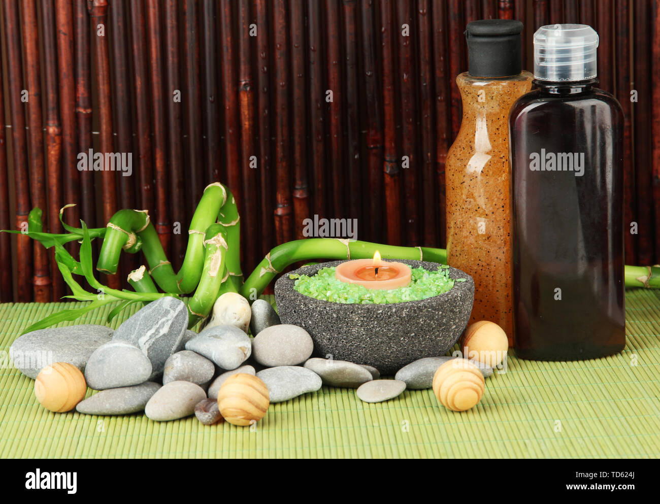 Still life with green bamboo plant and stones, on bamboo mat on color ...