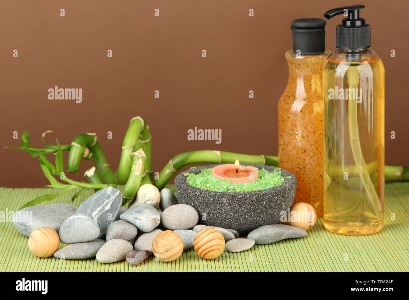Still life with green bamboo plant and stones, on bamboo mat on color ...