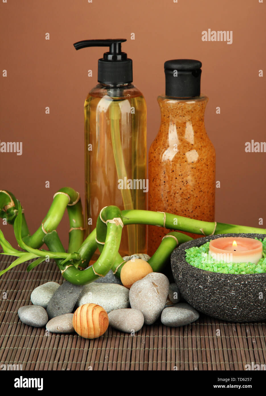 Still life with green bamboo plant and stones, on bamboo mat on color ...