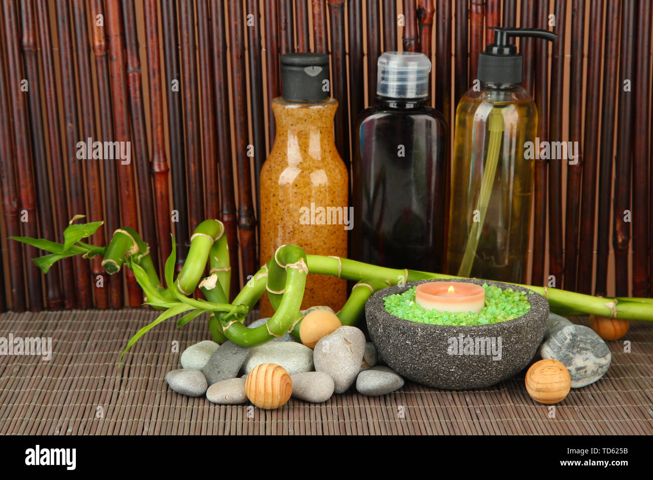 Still life with green bamboo plant and stones, on bamboo mat on color ...