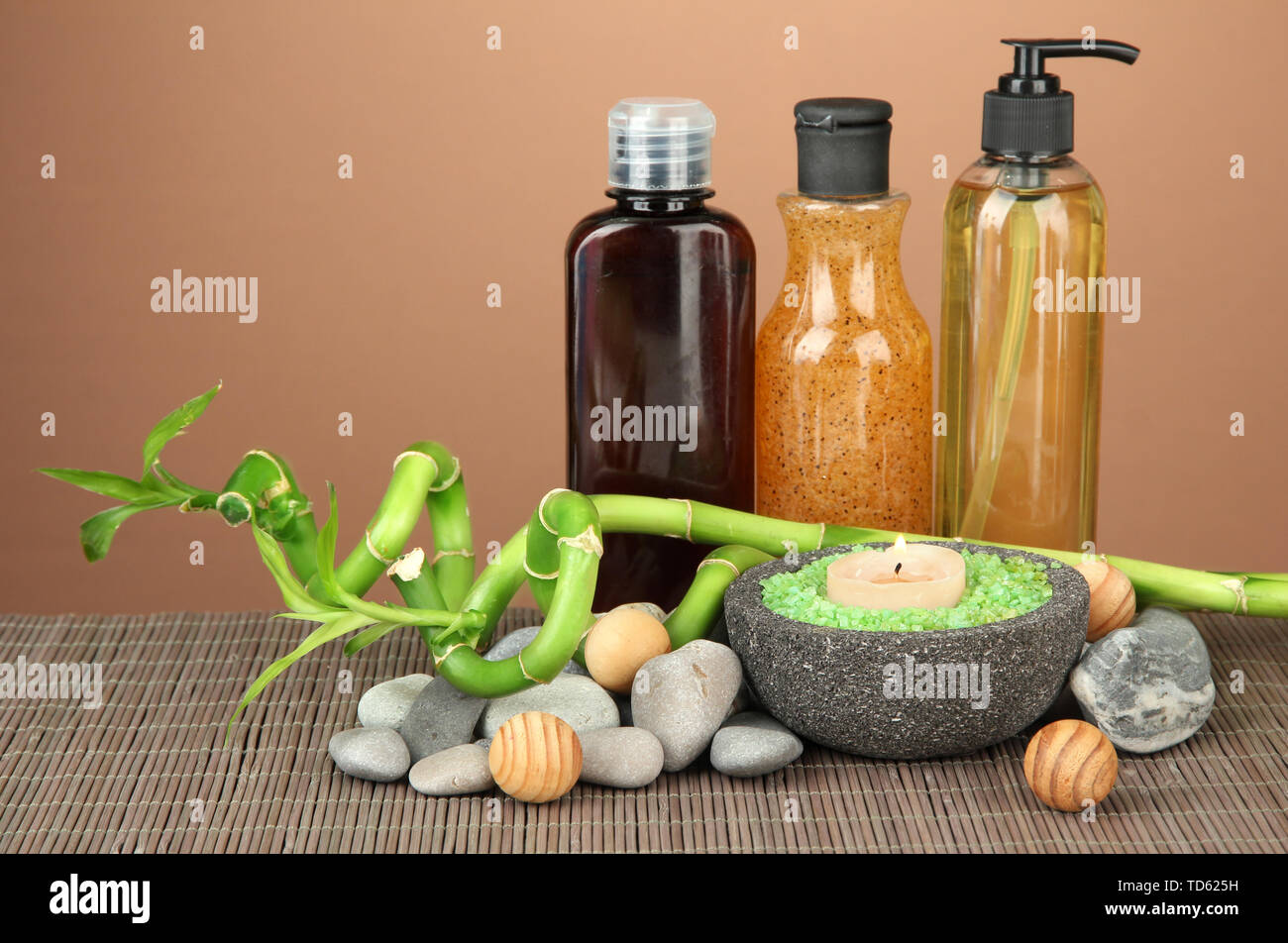 Still life with green bamboo plant and stones, on bamboo mat on color ...