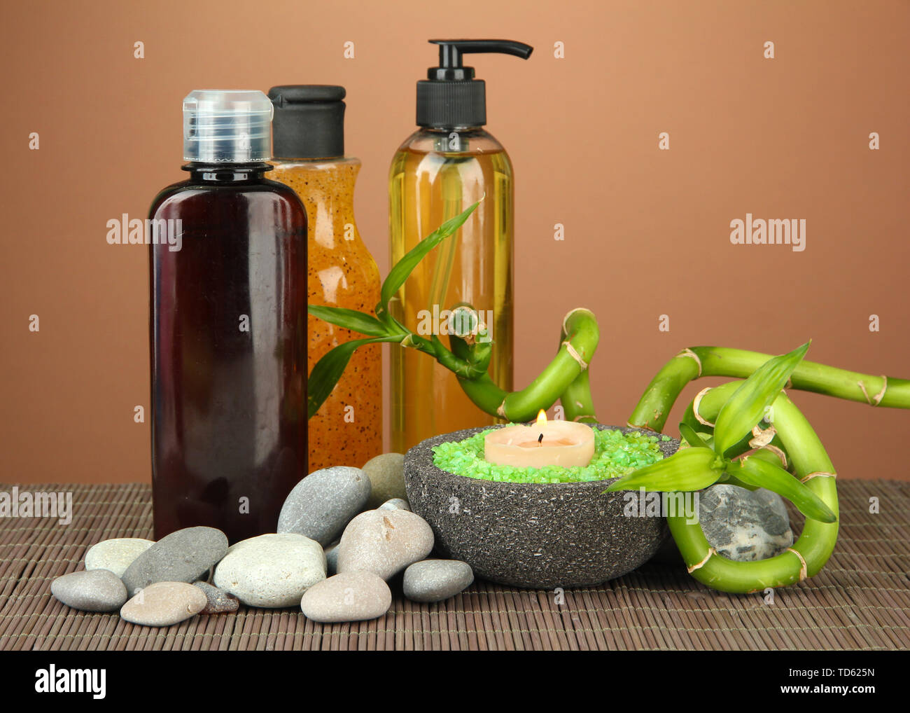 Still life with green bamboo plant and stones, on bamboo mat on color ...