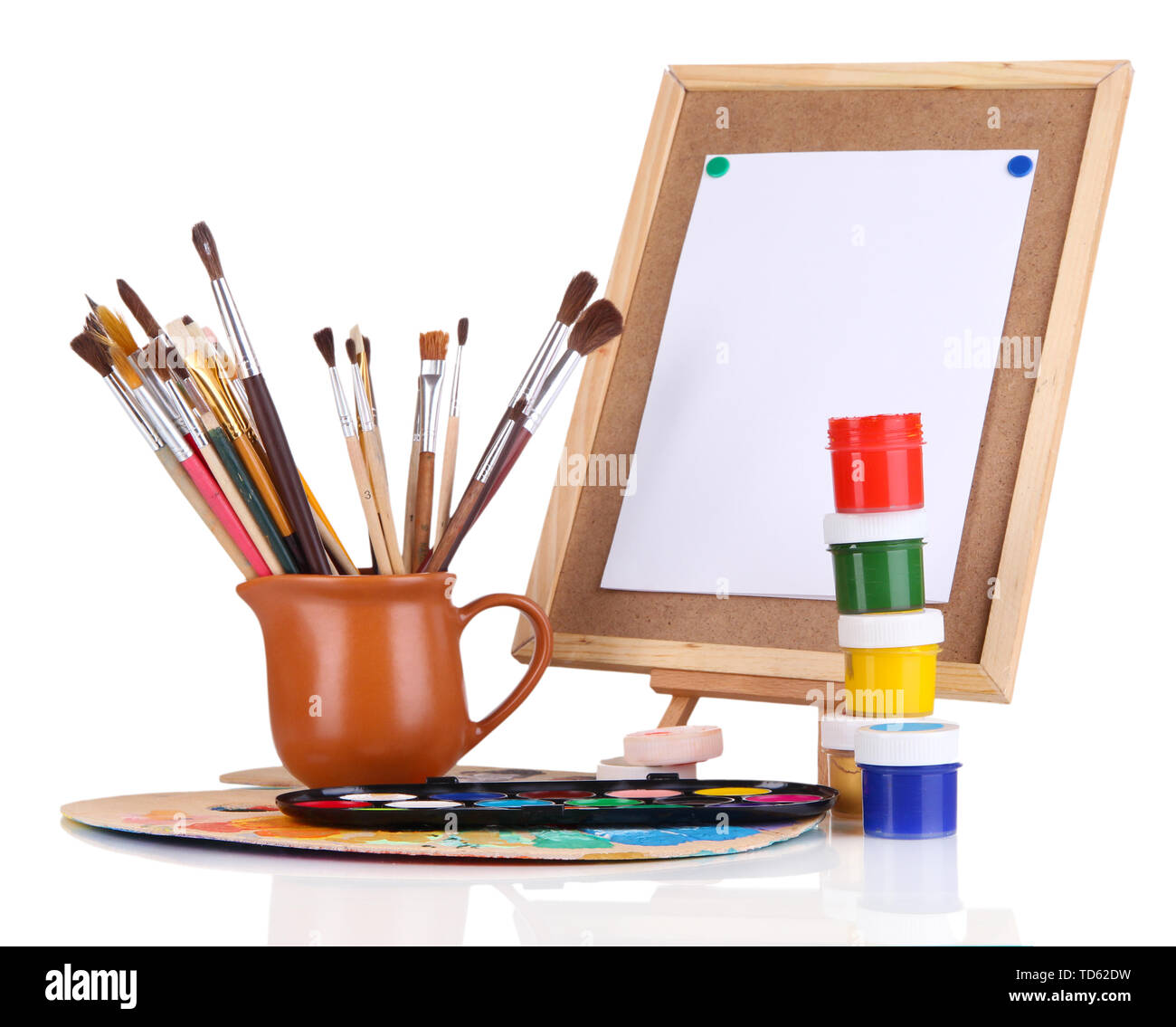 Small easel with sheet of paper and art supplies isolated on white ...
