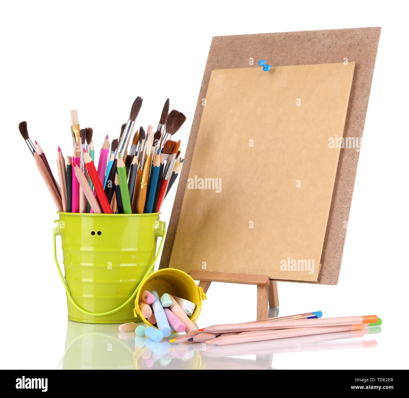 Small easel with sheet of paper with art supplies isolated on white ...