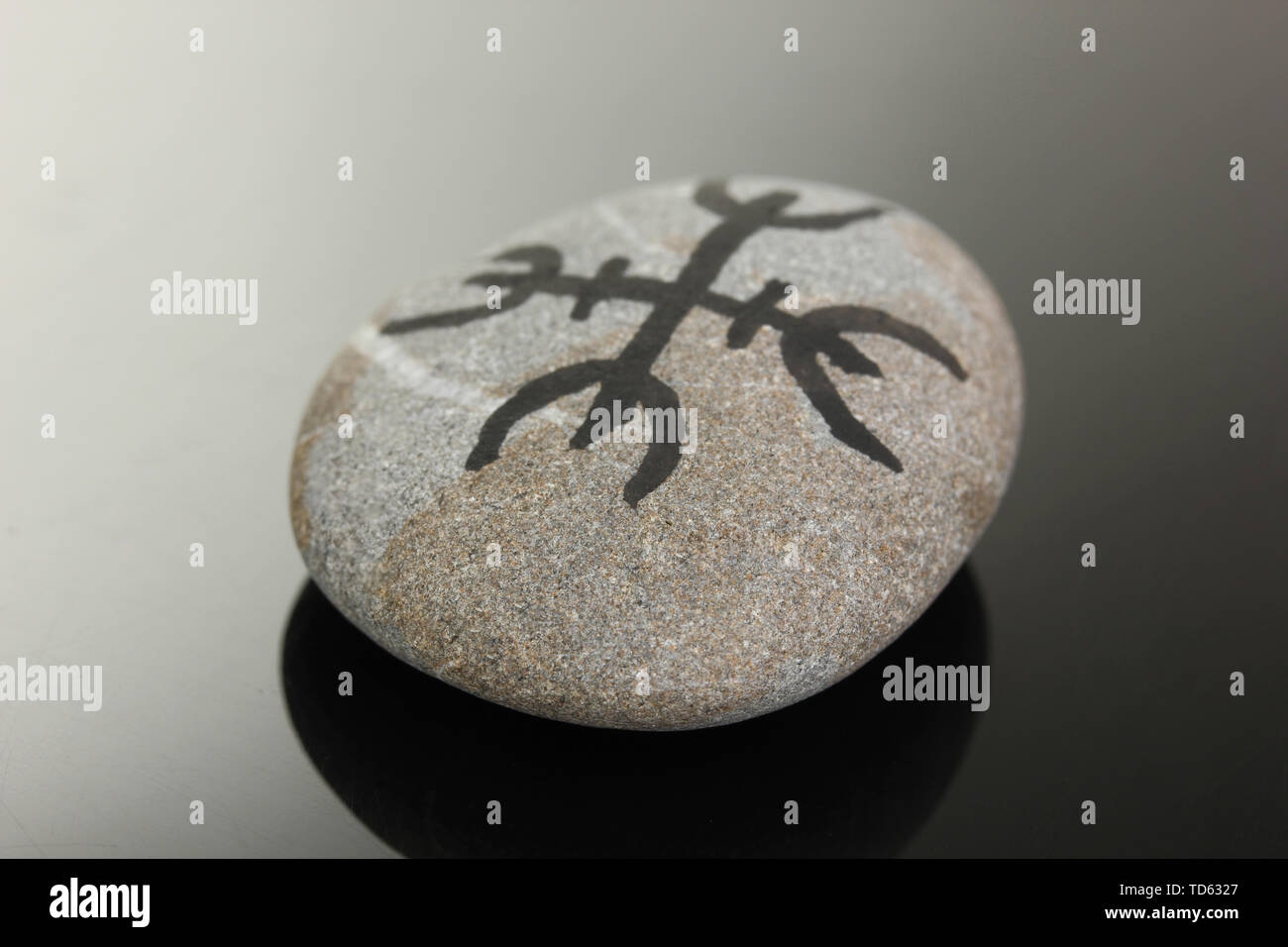 Fortune telling with symbols on stone on black background Stock Photo ...