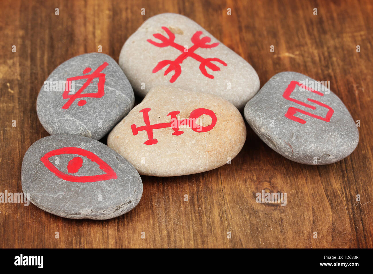 Fortune telling with symbols on stones on wooden background Stock Photo ...