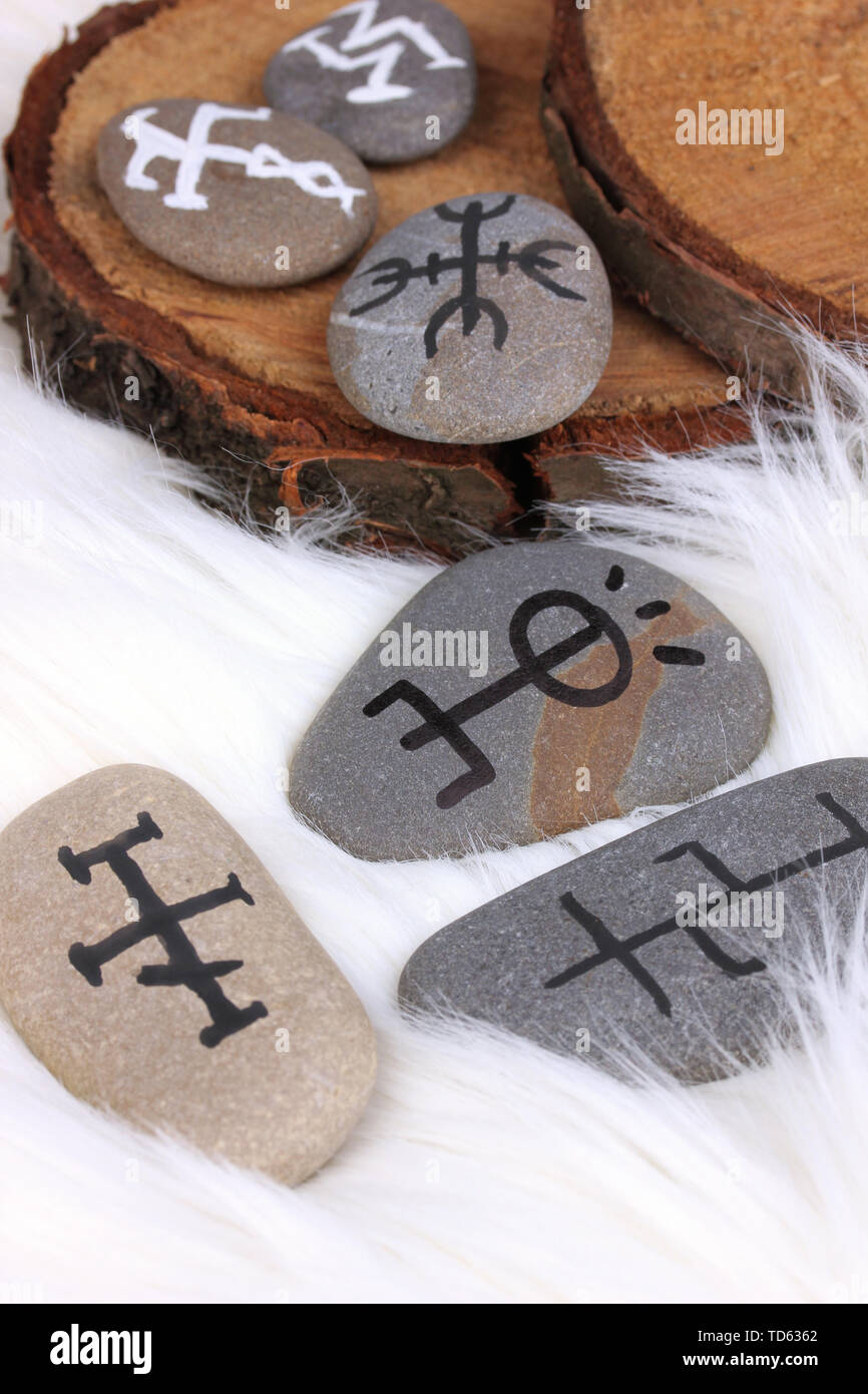 Fortune telling with symbols on stones on white fur background Stock ...