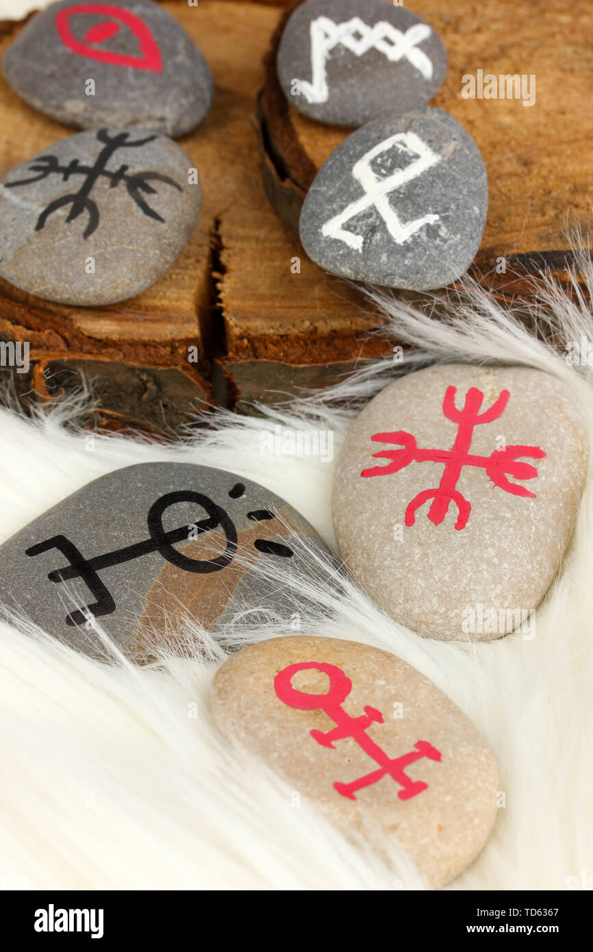 Fortune telling with symbols on stones on white fur background Stock ...