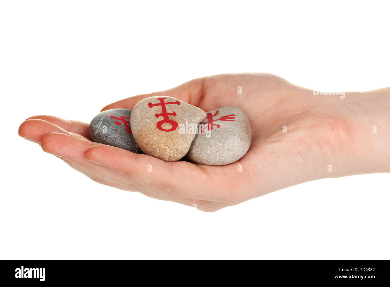 Fortune telling with symbols on stone in hand isolated on white Stock ...