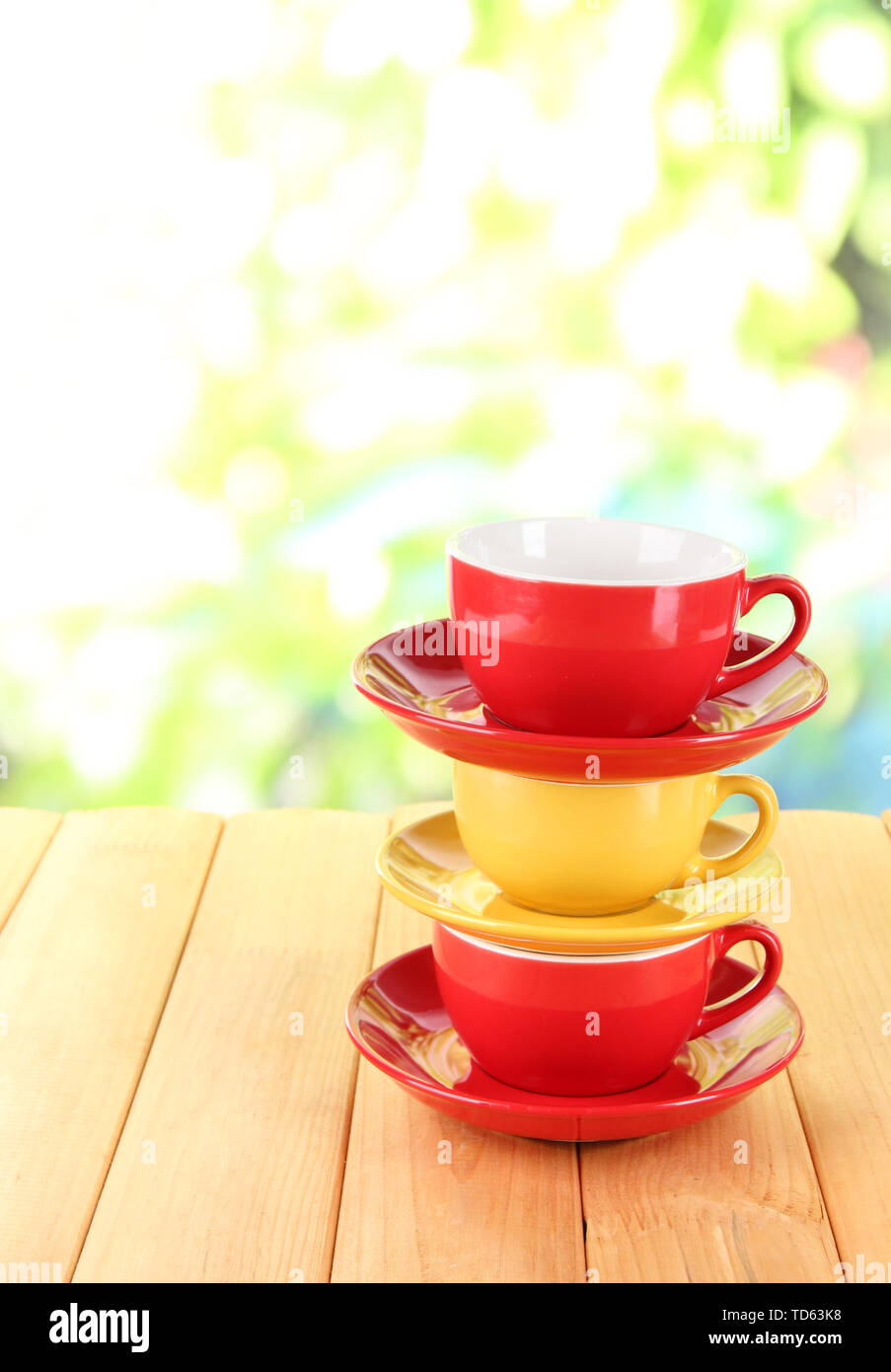 Three cups on nature background Stock Photo - Alamy
