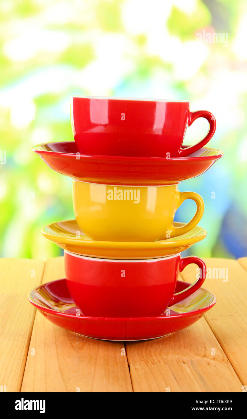 Three cups on nature background Stock Photo - Alamy
