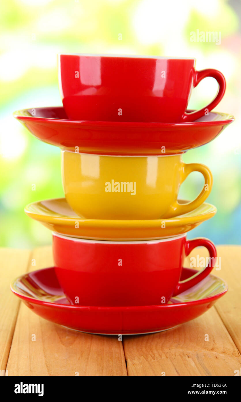 Three cups on nature background Stock Photo - Alamy