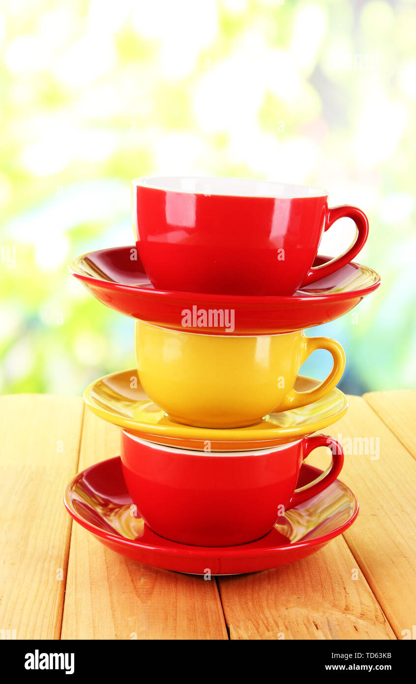 Three cups on nature background Stock Photo - Alamy