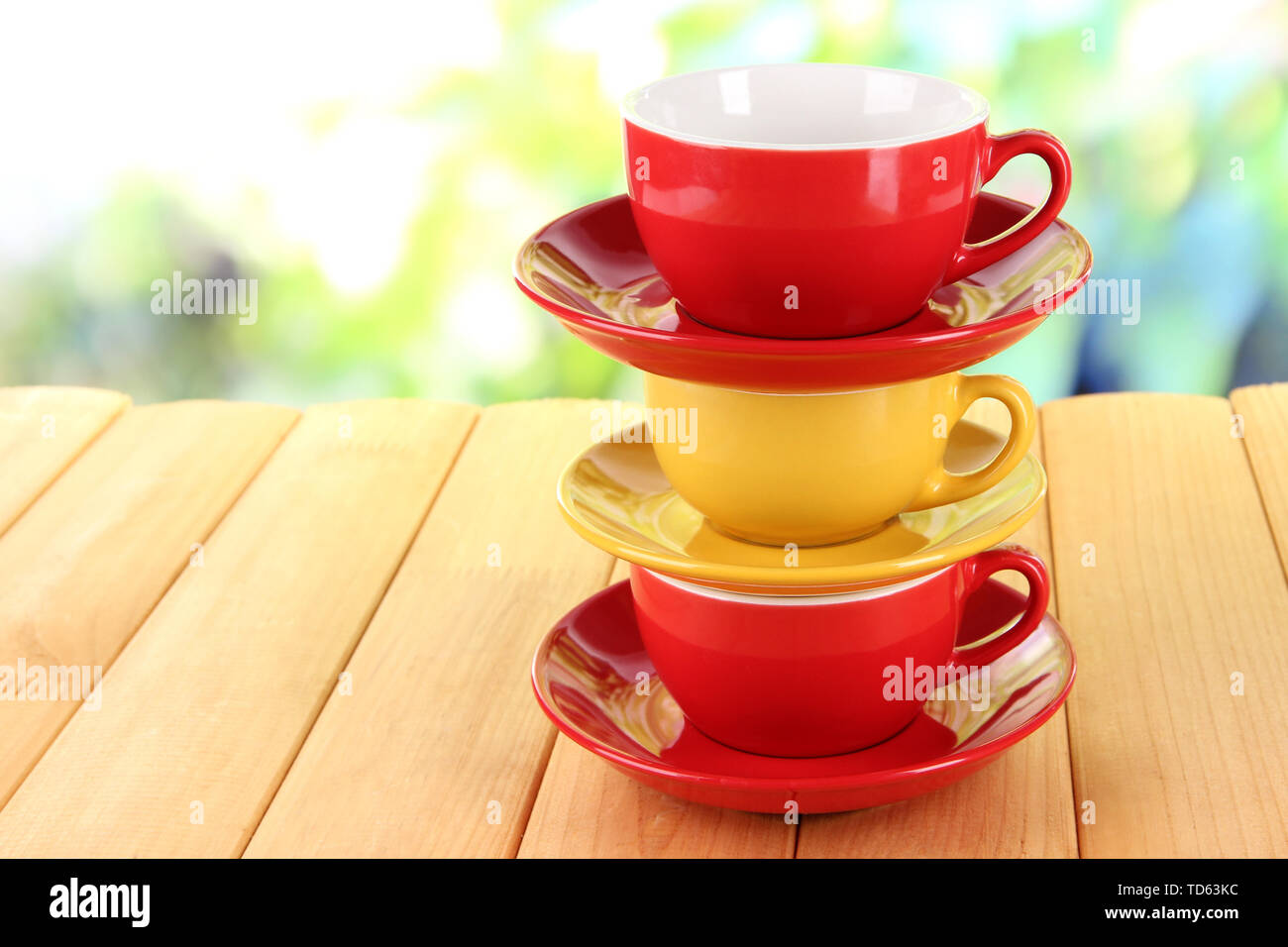 Three cups on nature background Stock Photo - Alamy