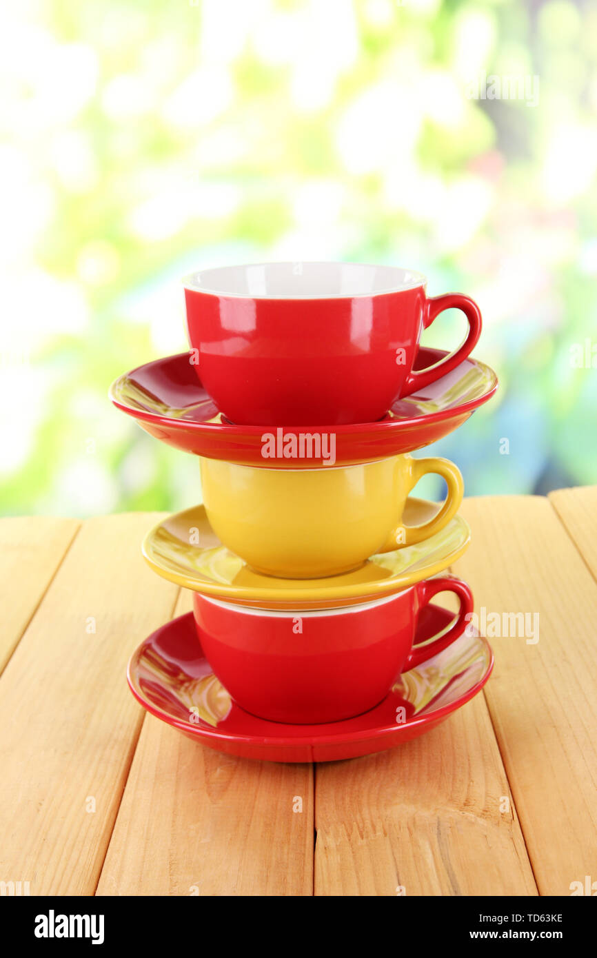 Three cups on nature background Stock Photo - Alamy