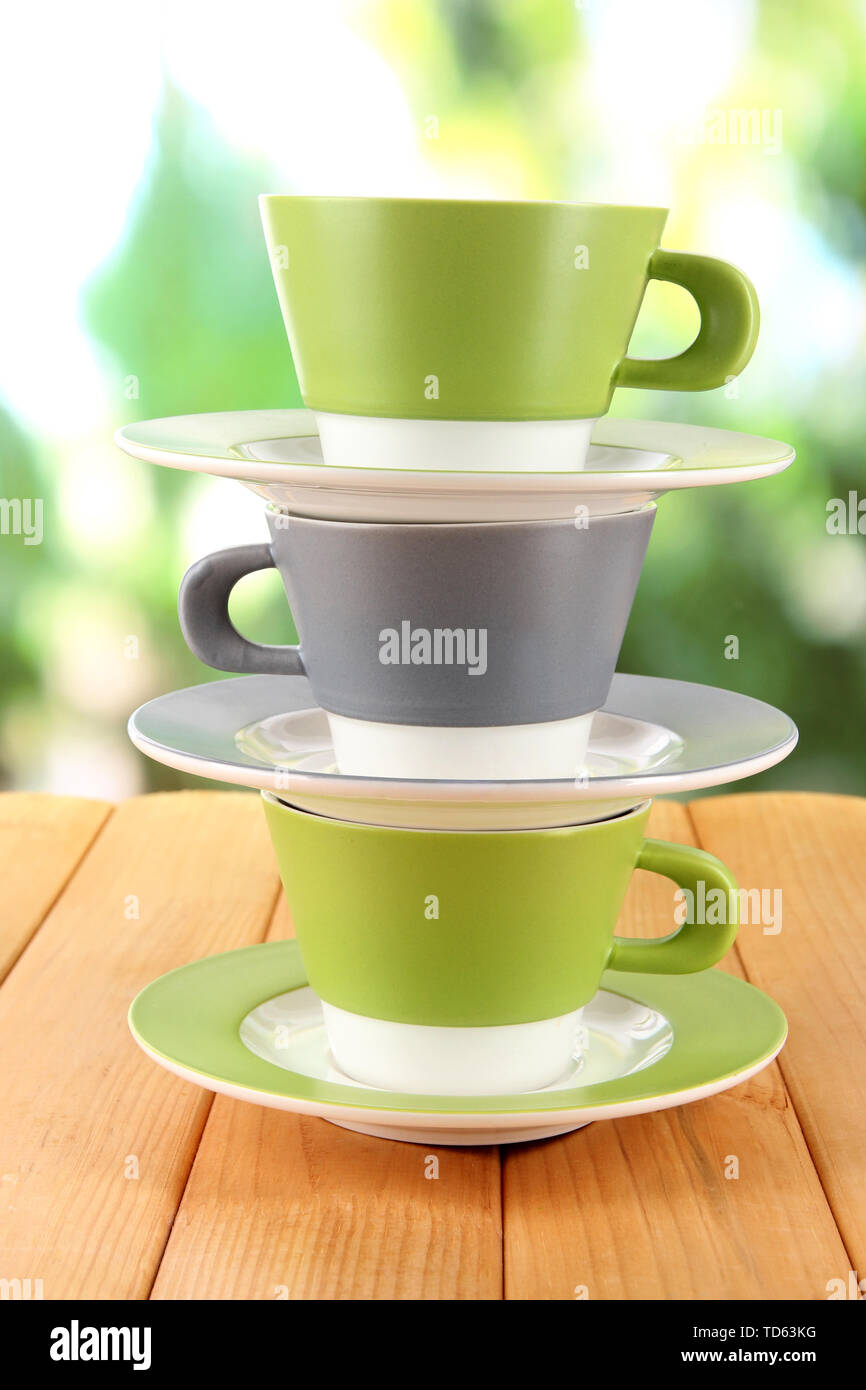 Three cups on nature background Stock Photo - Alamy