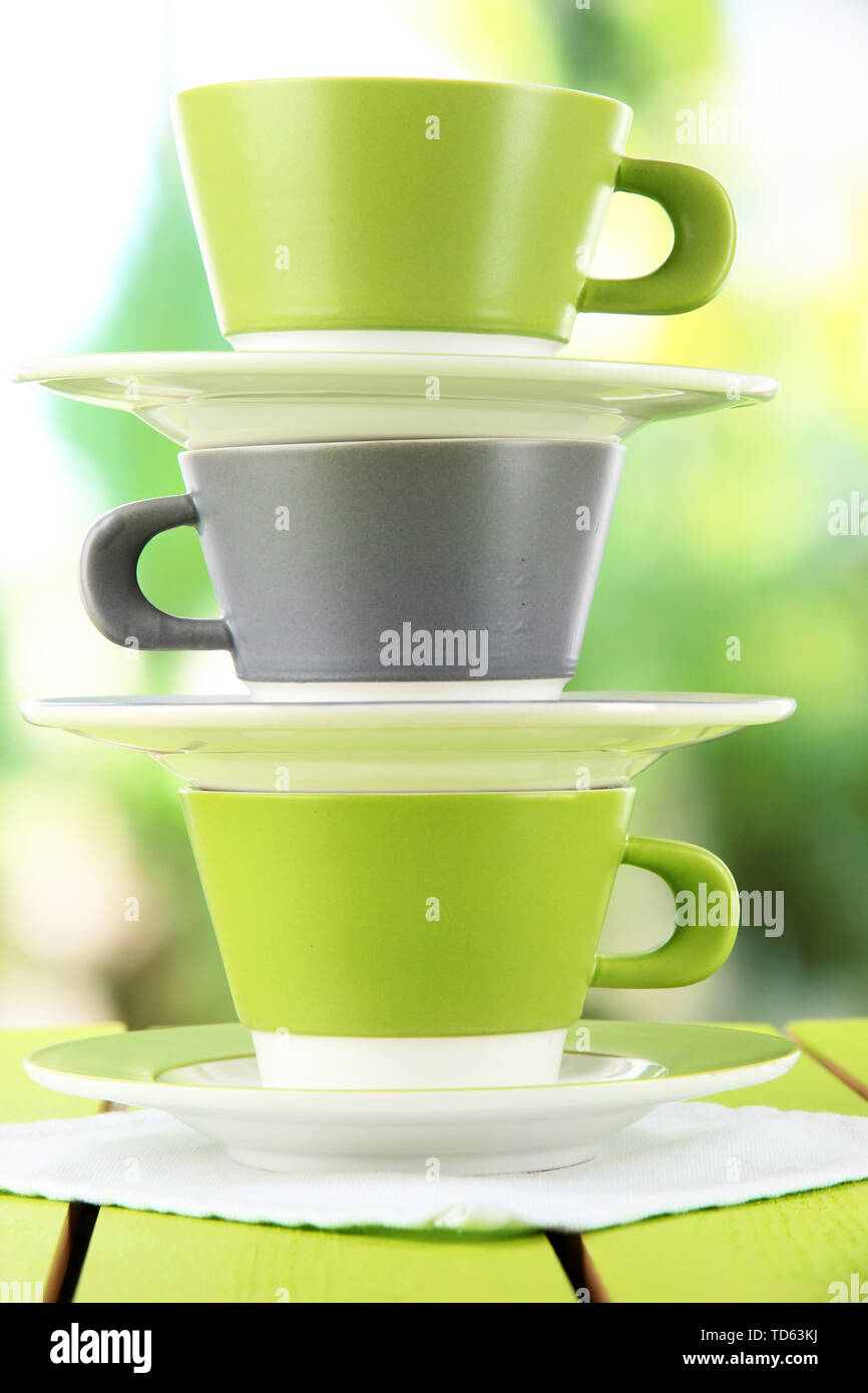 Three cups on nature background Stock Photo - Alamy