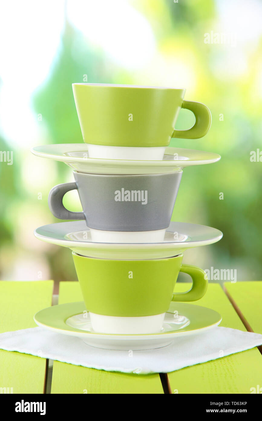 Three cups on nature background Stock Photo - Alamy