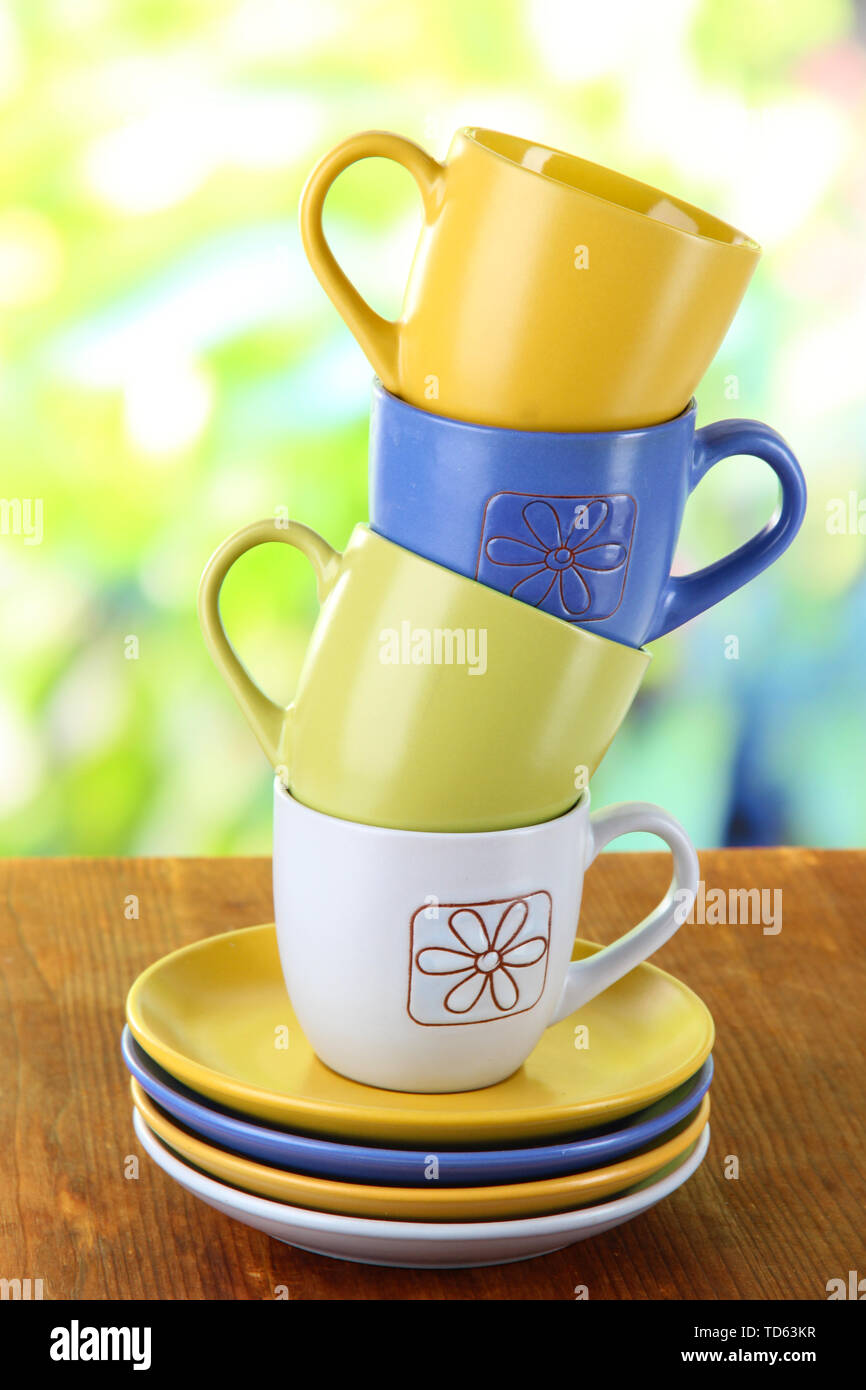 Bright cups on nature background Stock Photo - Alamy