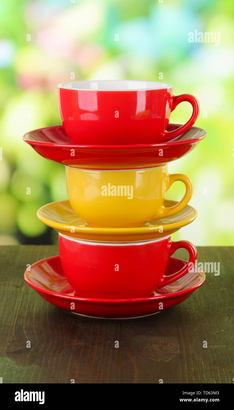 Three cups on nature background Stock Photo - Alamy