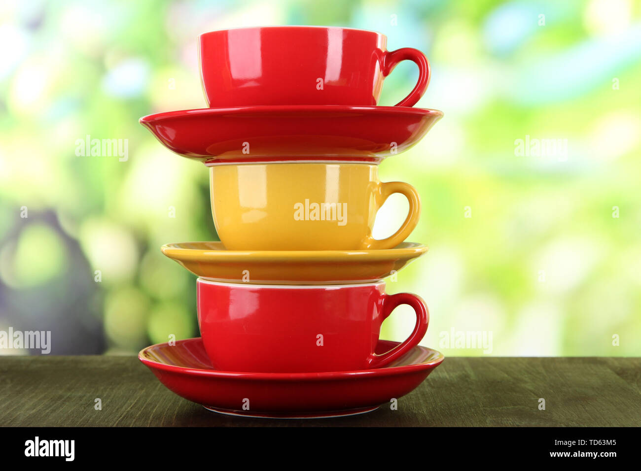 Three cups on nature background Stock Photo - Alamy