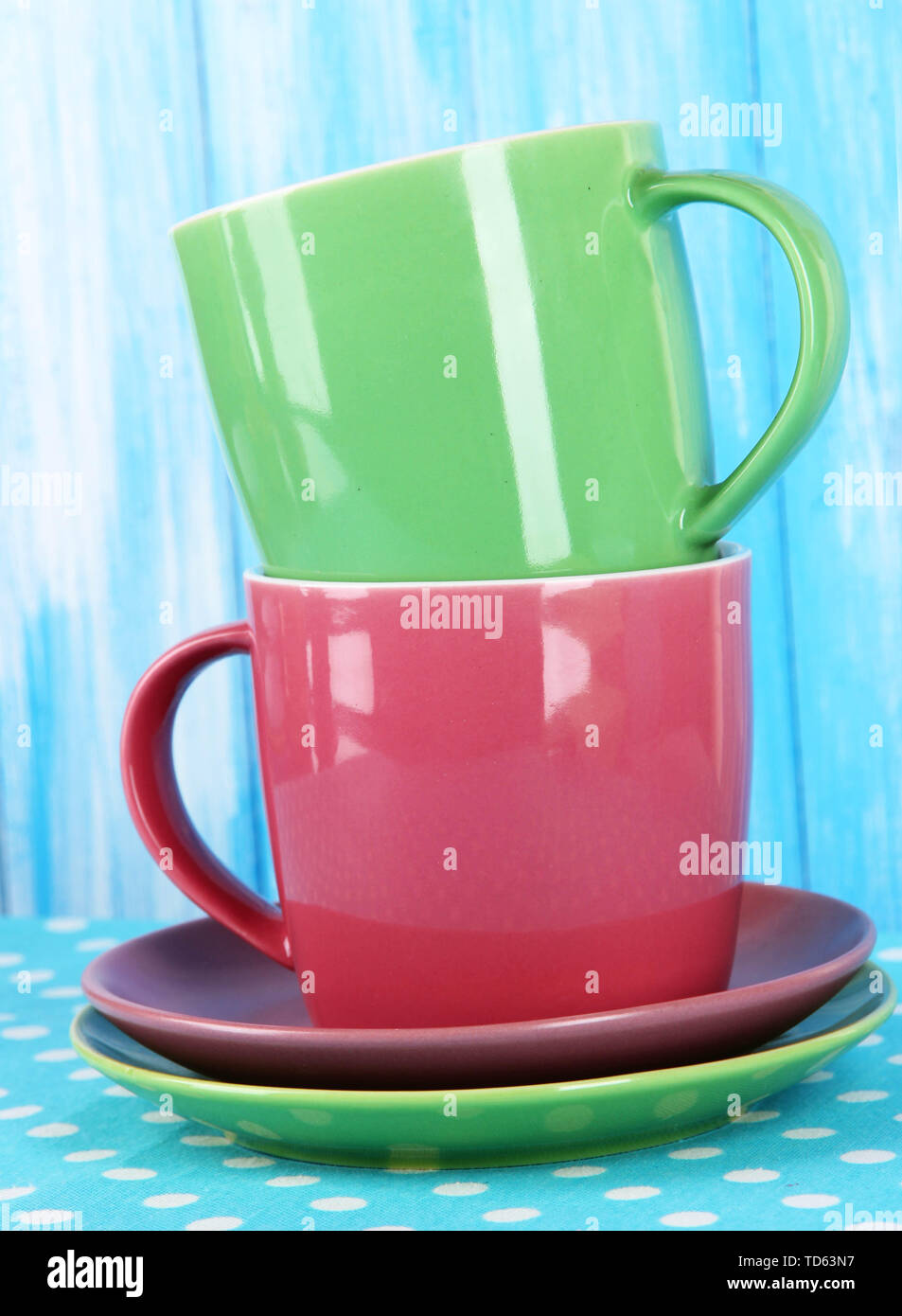 Two cups on blue background Stock Photo - Alamy
