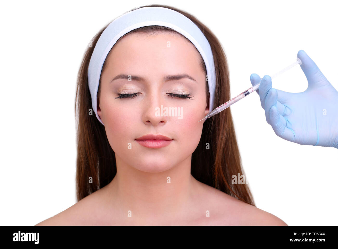 Young woman receiving plastic surgery injection on her face close up ...