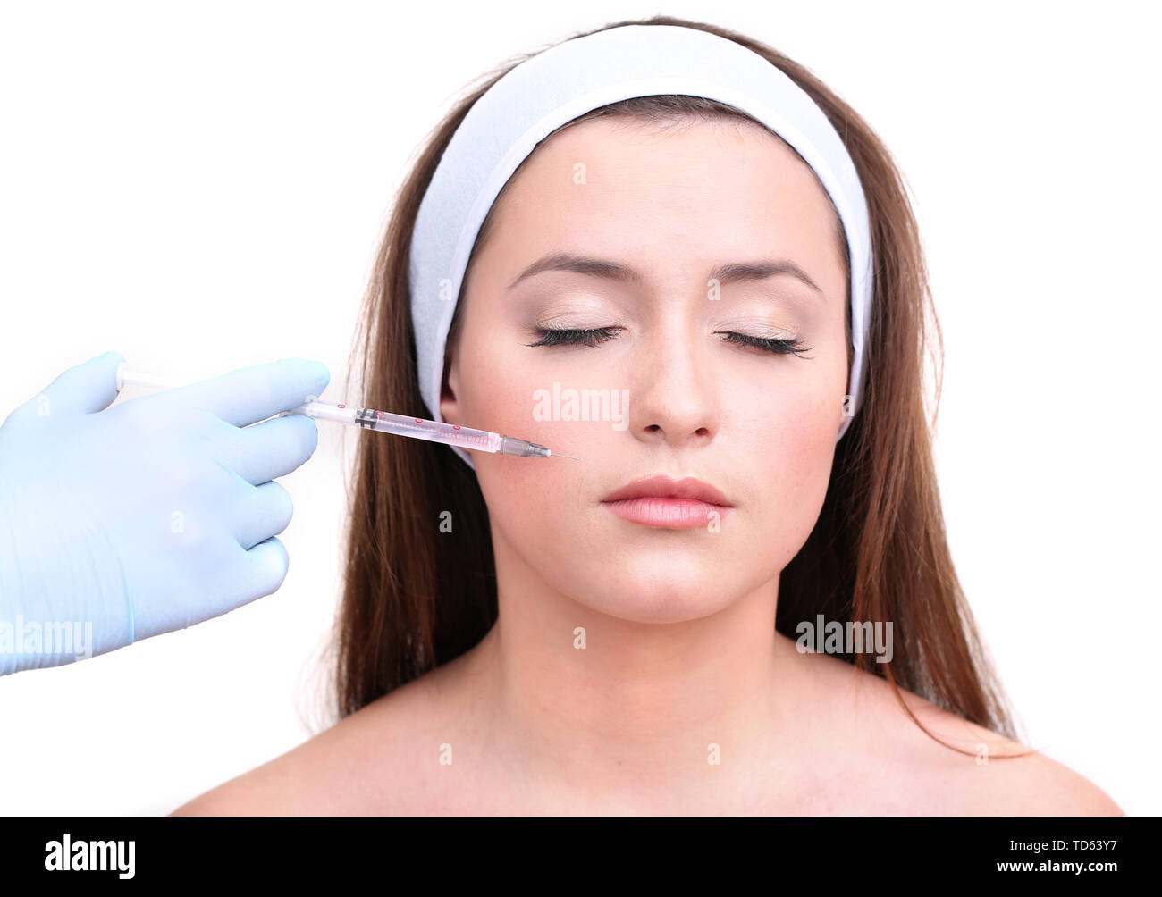 Young woman receiving plastic surgery injection on her face close up ...
