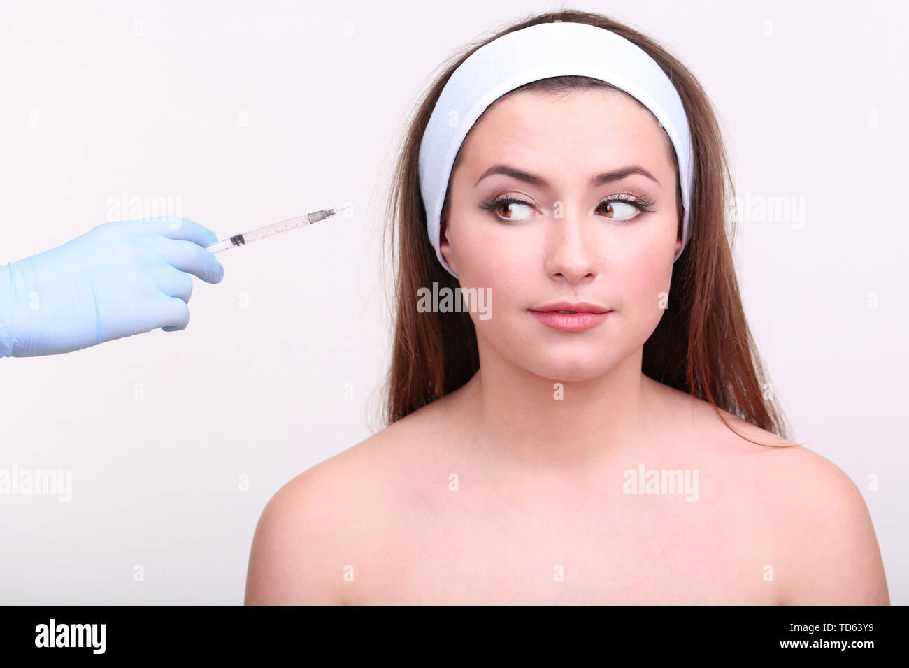 Young woman receiving plastic surgery injection on her face close up ...