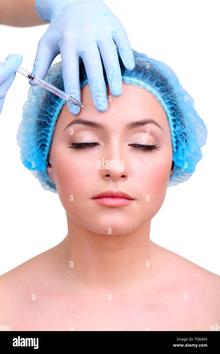 Young woman receiving plastic surgery injection on her face close up ...