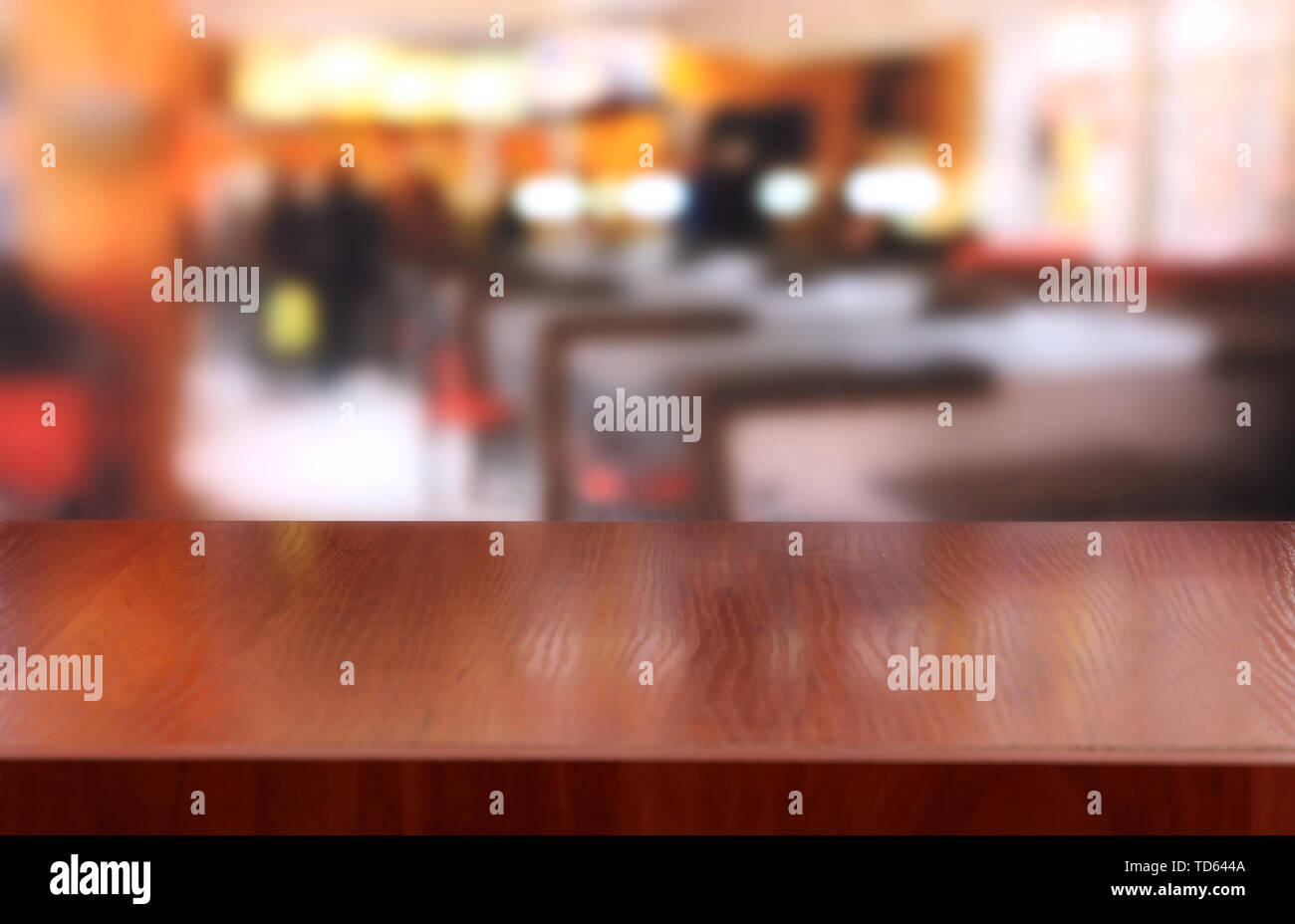 Wooden table on cafe background Stock Photo - Alamy