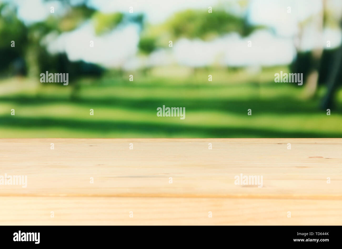 Wooden table on park background Stock Photo - Alamy