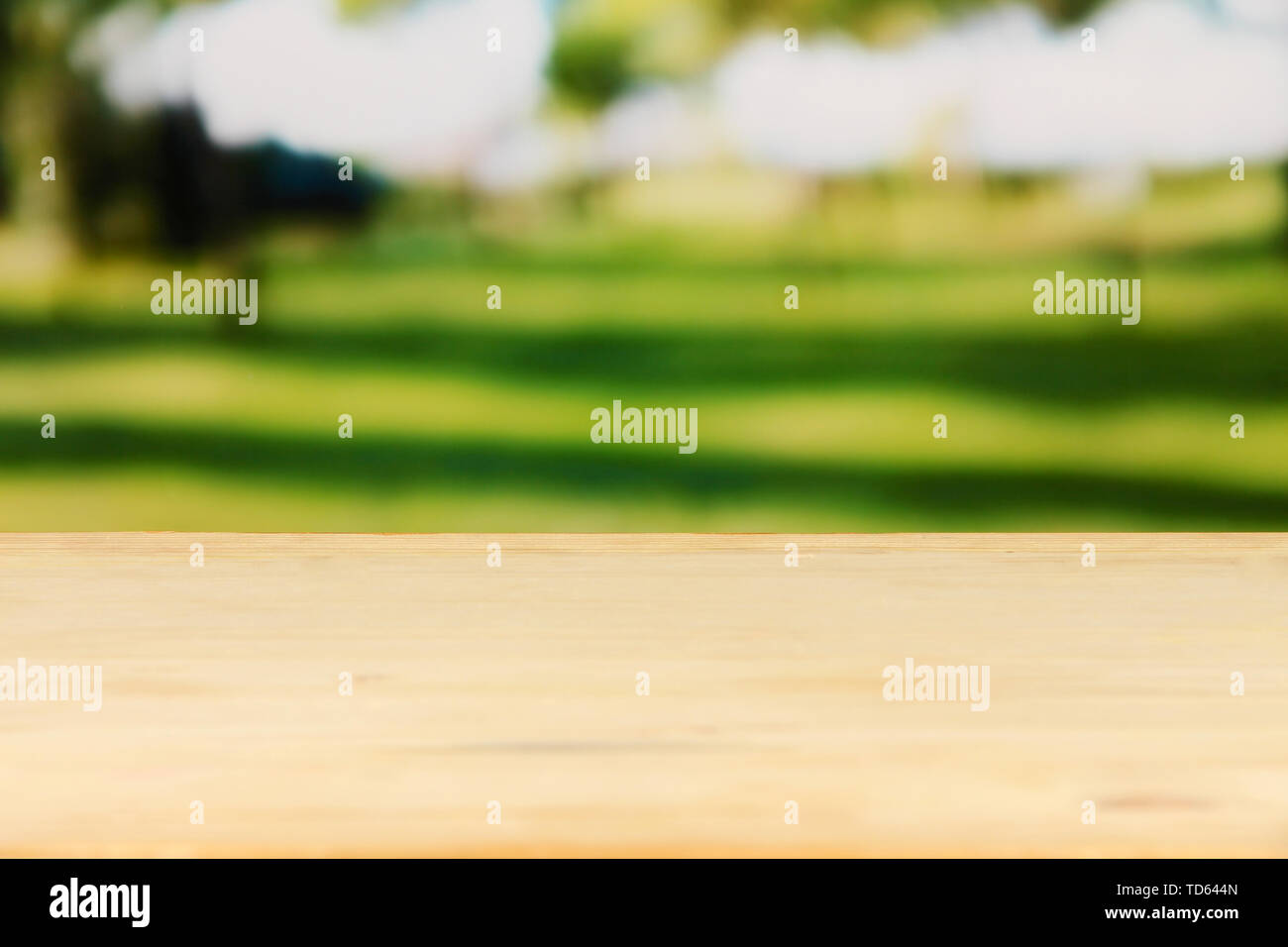 Wooden table on park background Stock Photo - Alamy